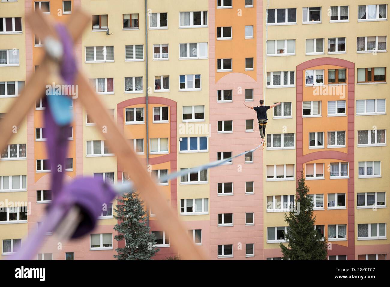 A tightrope walker is walking on the rope at a high altitude Stock ...
