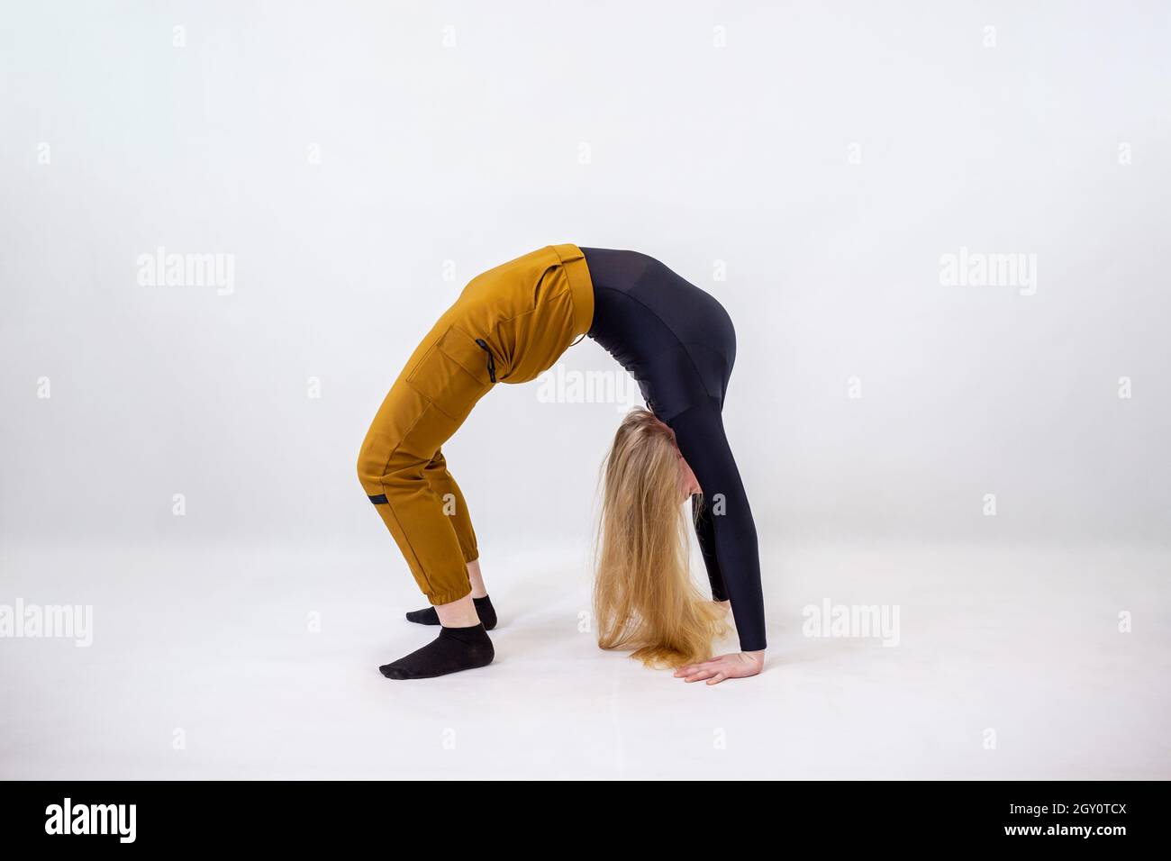 Young blonde blue-eyed dancer woman on white background Stock Photo - Alamy