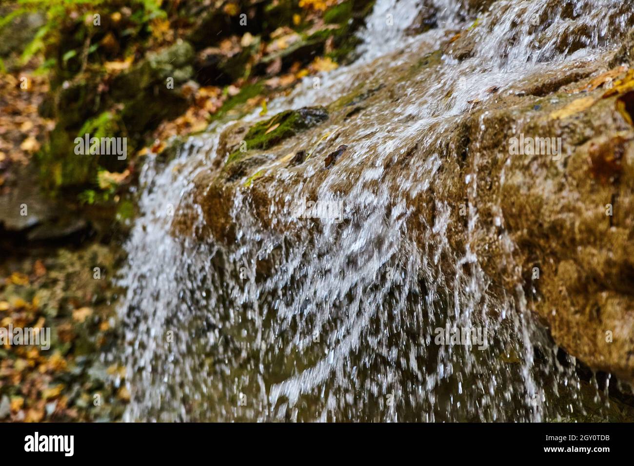Detail of waterfall water flowing over edge blurred Stock Photo - Alamy