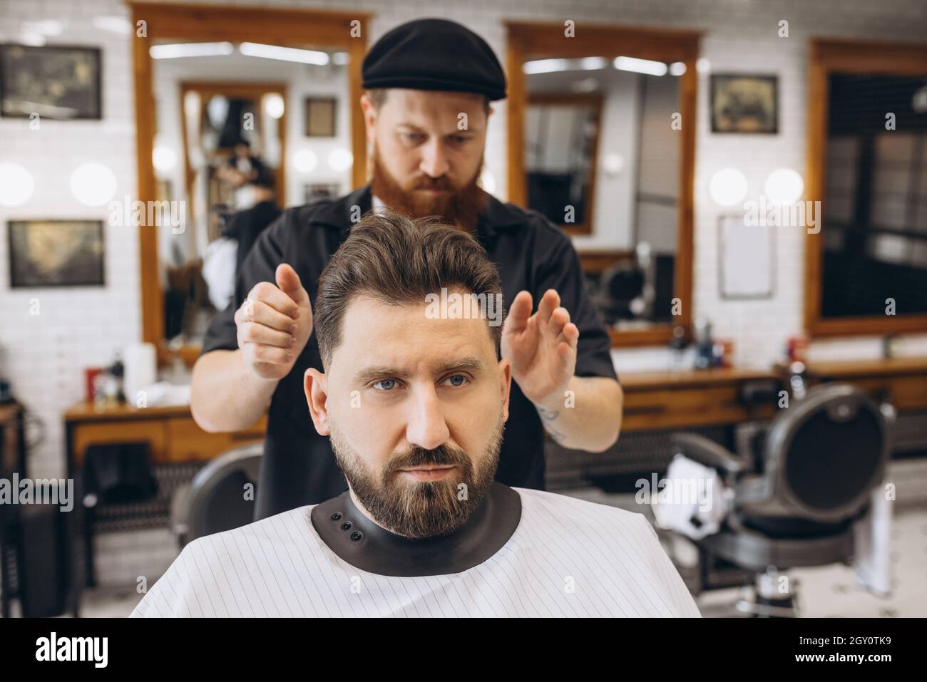 Man getting haircut at the barbershop. Professional barber at work ...
