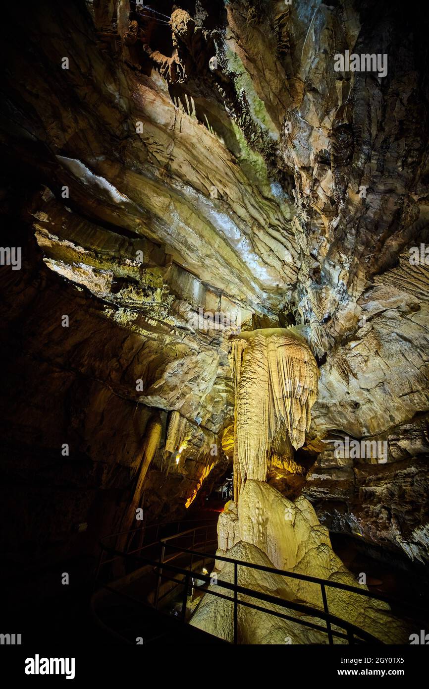 Cave formations on walkway underground with stalagmites and stalactites ...