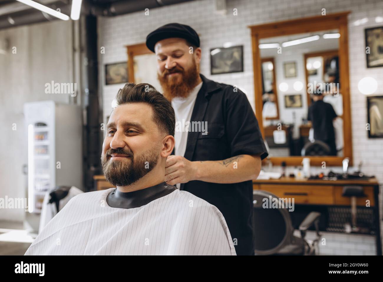 Stylish man getting haircut at the barbershop. Professional barber at ...