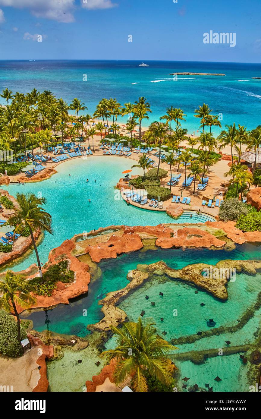 View from resort balcony with sting ray pool, swimming pool, palm trees ...