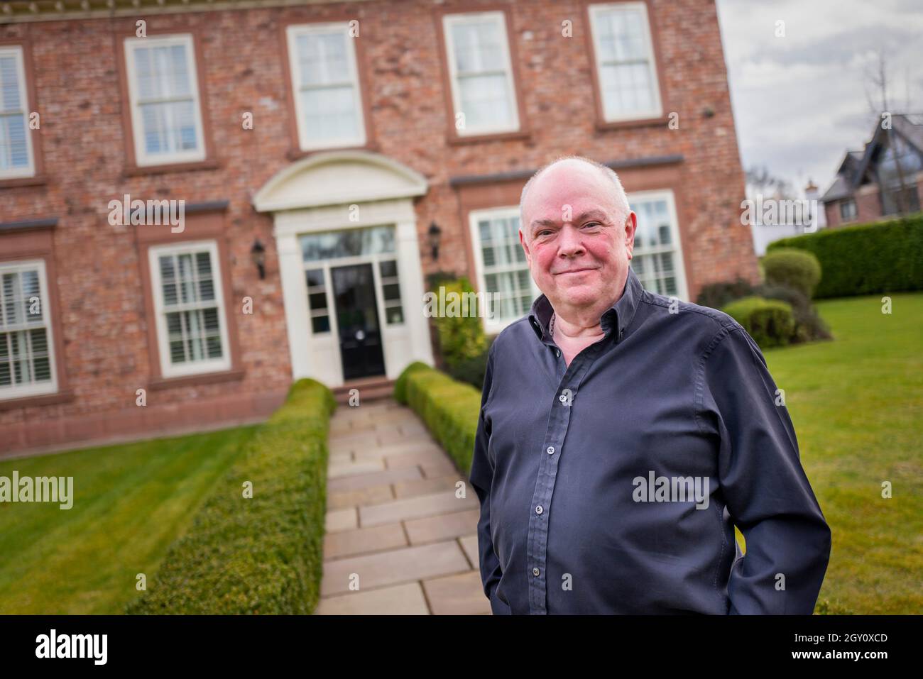 Sir Bernard Gray poses for a portrait at home in Bowden, UK Stock Photo ...