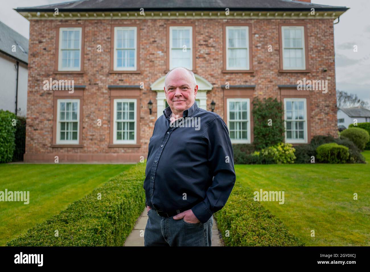 Sir Bernard Gray poses for a portrait at home in Bowden, UK Stock Photo ...
