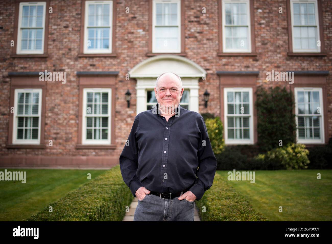 Sir Bernard Gray poses for a portrait at home in Bowden, UK Stock Photo ...
