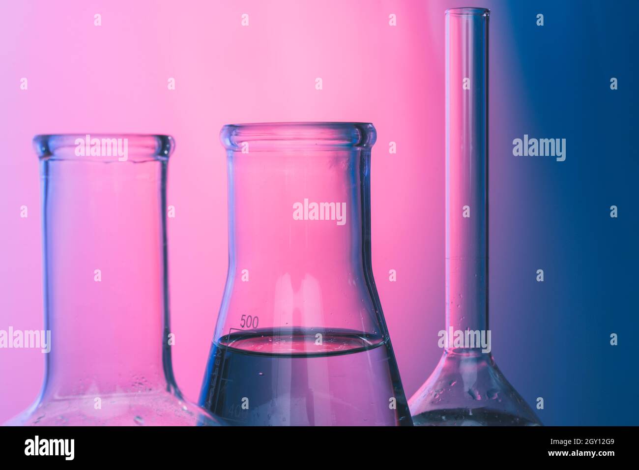 Laboratory glass tubes with chemicals on bright pink background Stock ...
