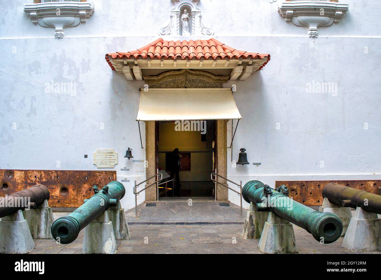 Small entrance door decorated with colonial cannons in the National ...
