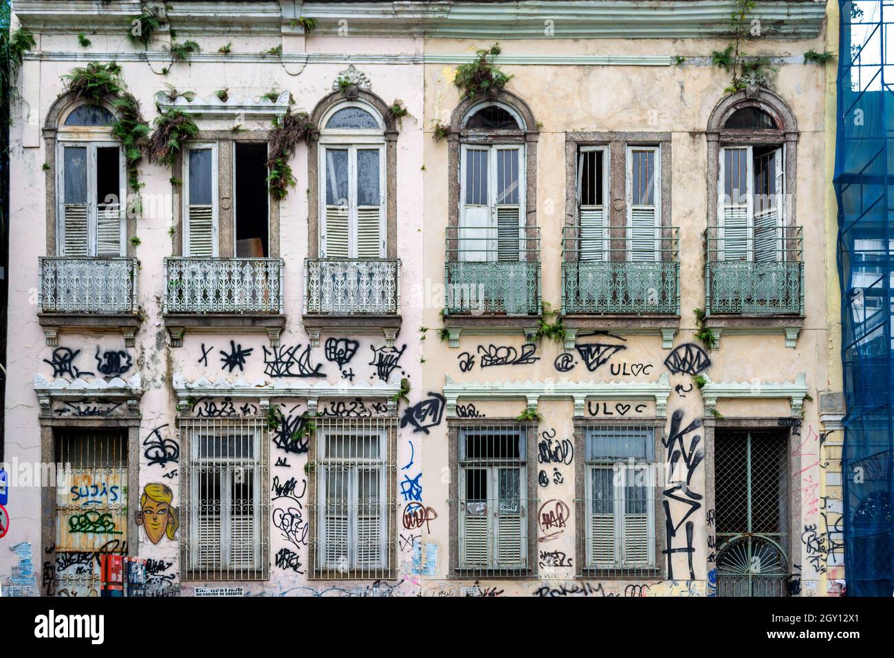 Facade of an old building with a pattern of windows and graffiti in 'La ...