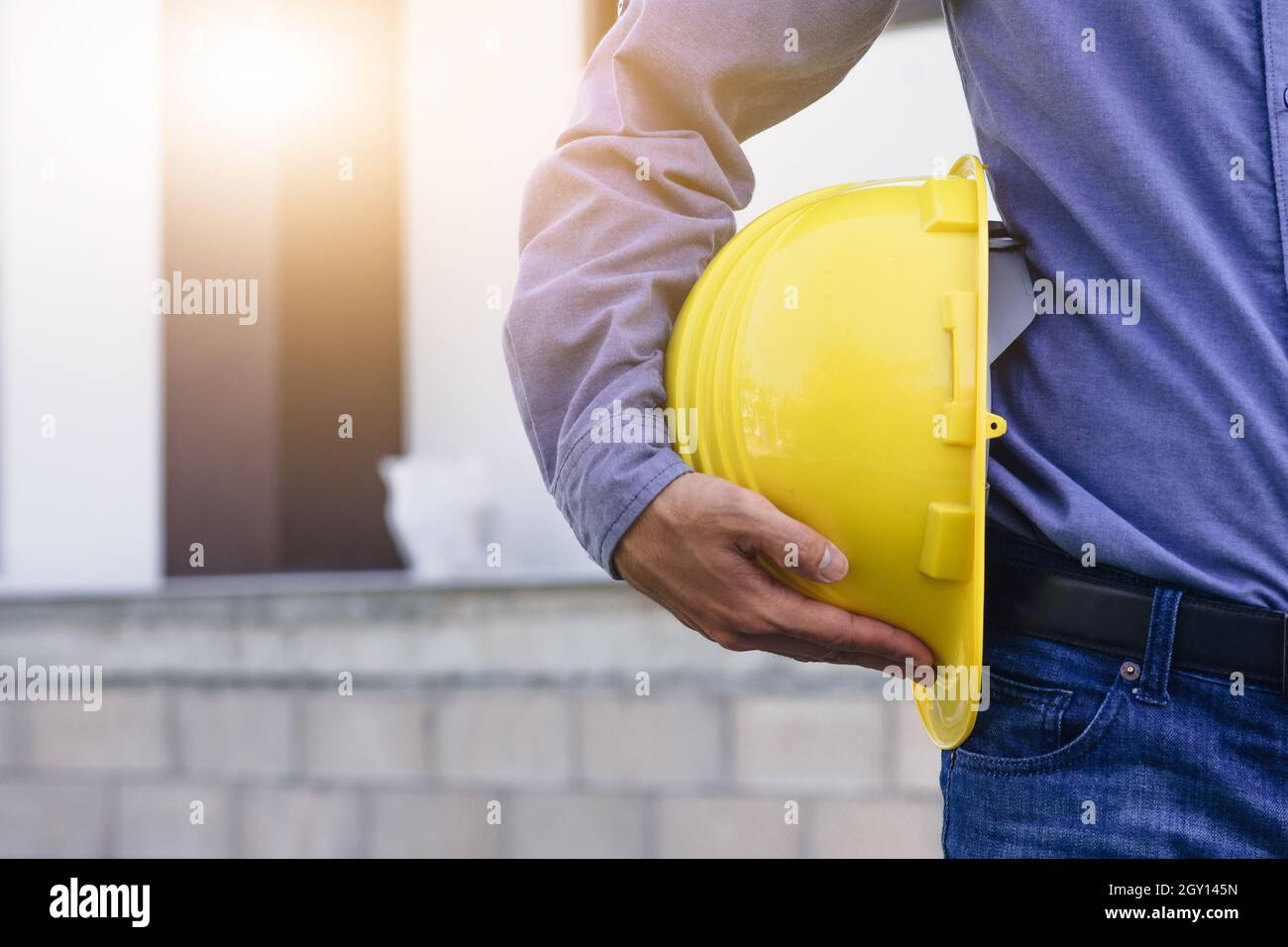 Architecture Engineer holding hard hat on site building construction ...