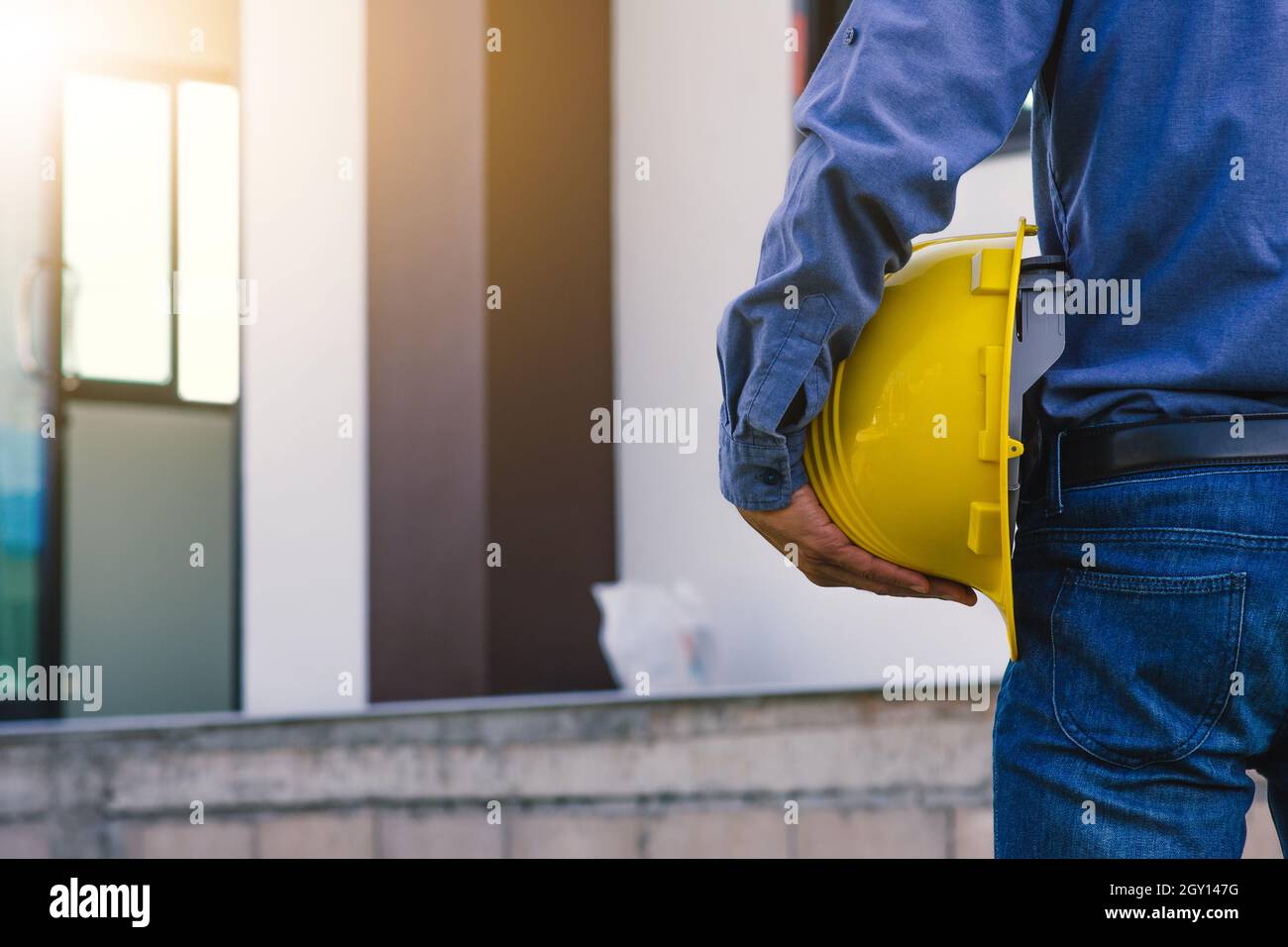 Architecture Engineer holding hard hat on site building construction ...