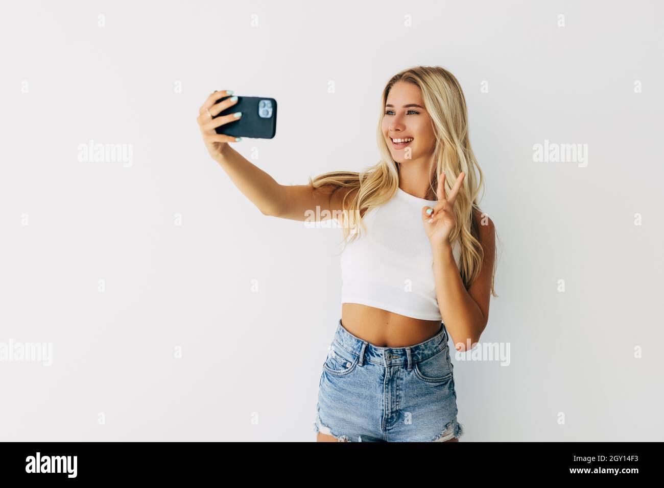 Photo of nice young woman wearing casual clothes taking selfie while ...