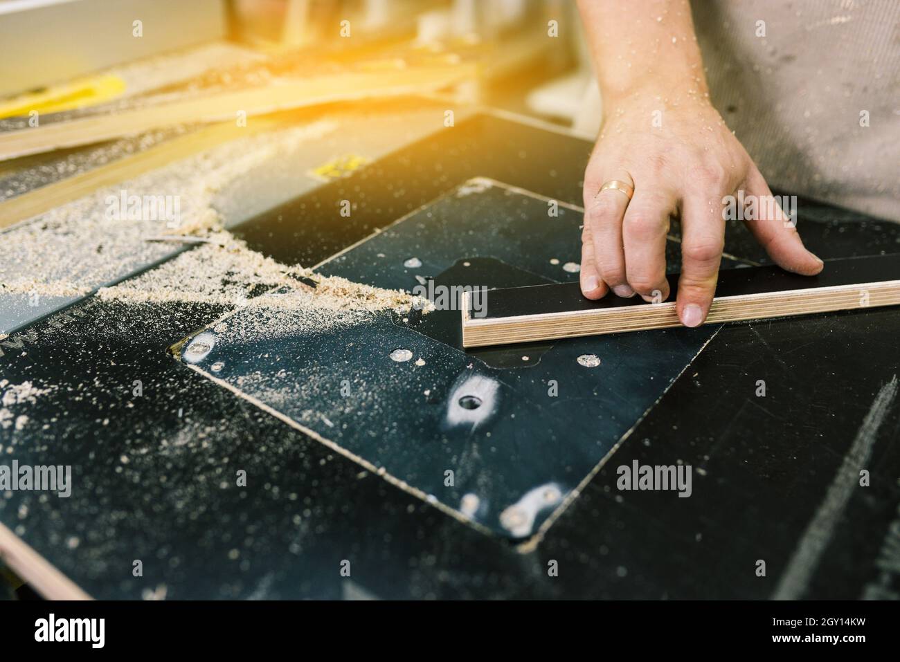 Worker works on woodworking equipment. Manufacturing of wooden ...