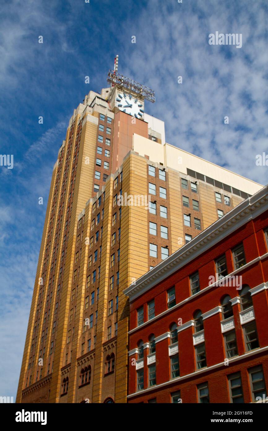 Large Lansing yellow skyscraper next to a red building Stock Photo - Alamy