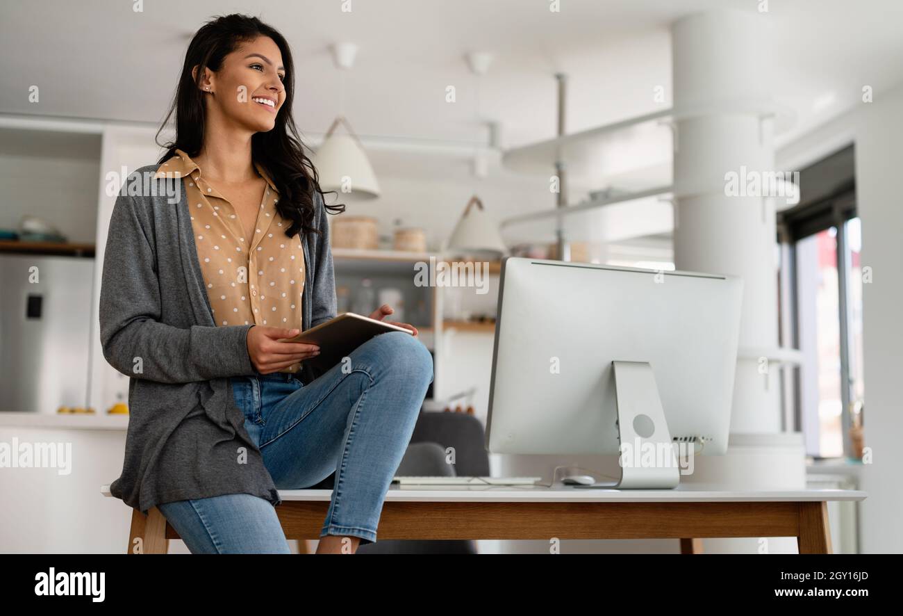 Beautiful young woman working on computer. Technology, people, work ...