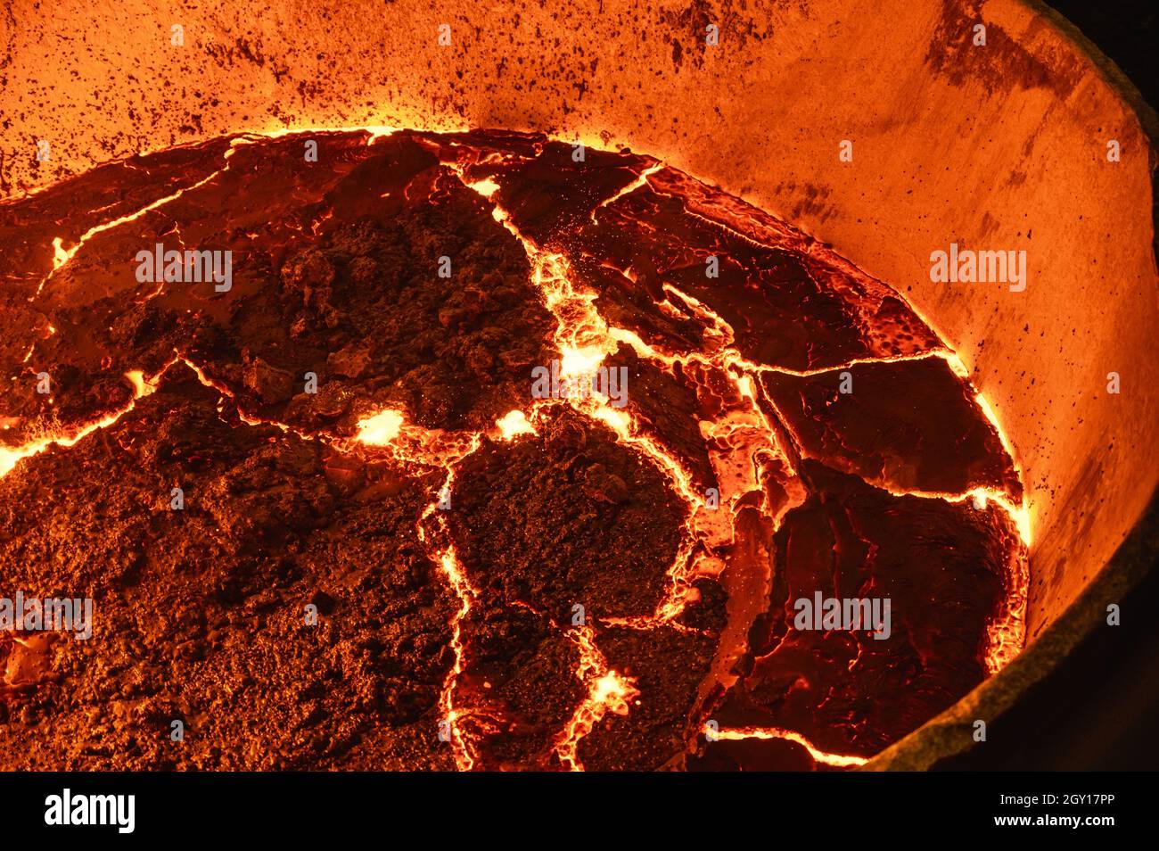 The surface of a hot liquid slag in a metallurgical ladle. Thick crust ...