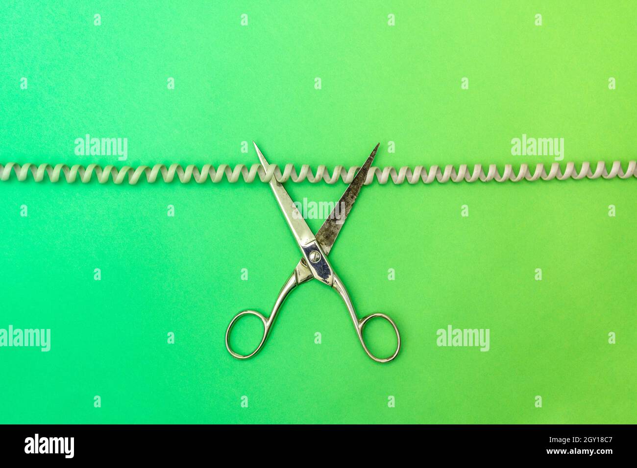 Phone cord being cut by scissors. Concept disconnected communication ...