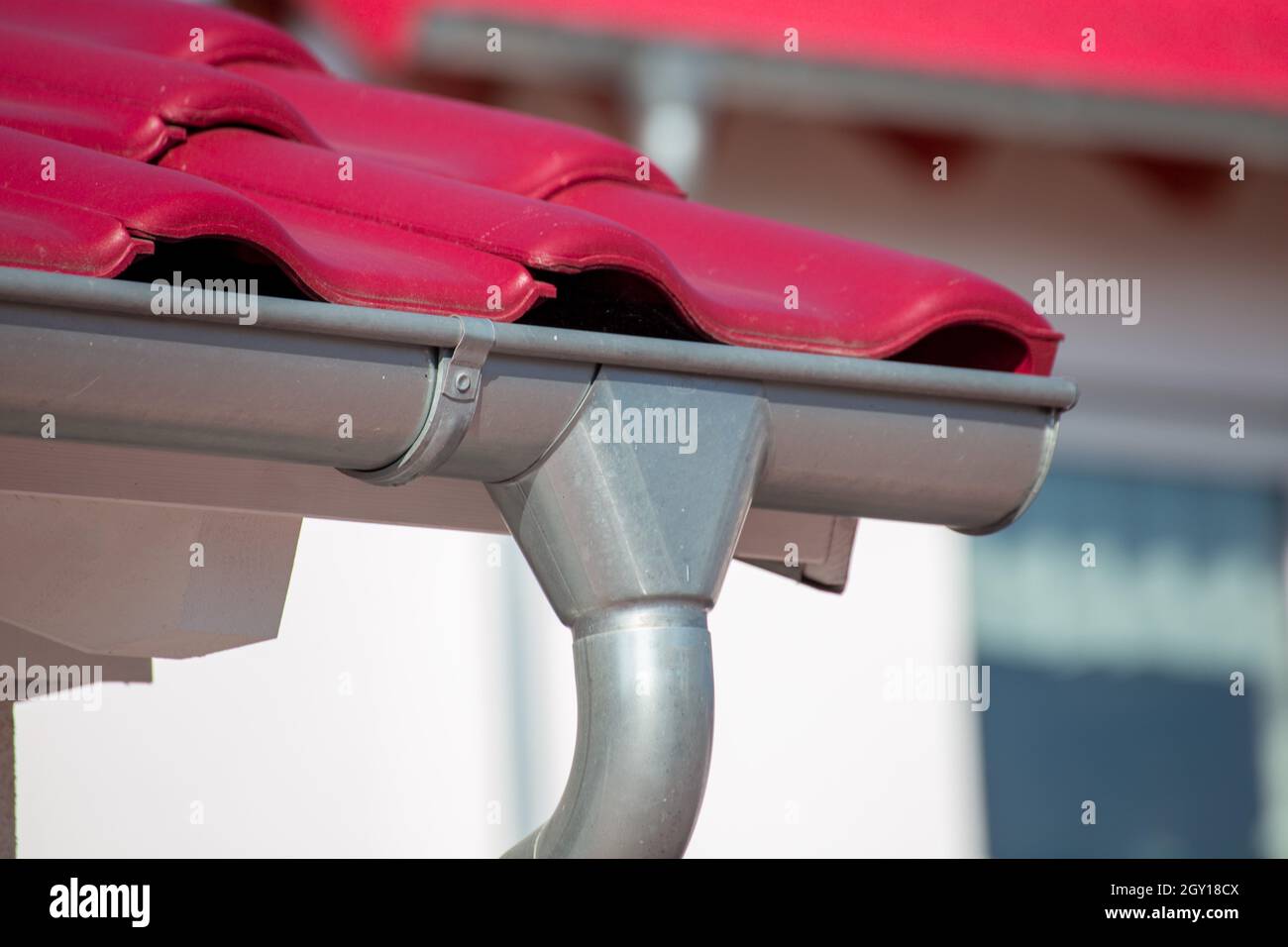 Roof gutter on a new tiled roof Stock Photo - Alamy