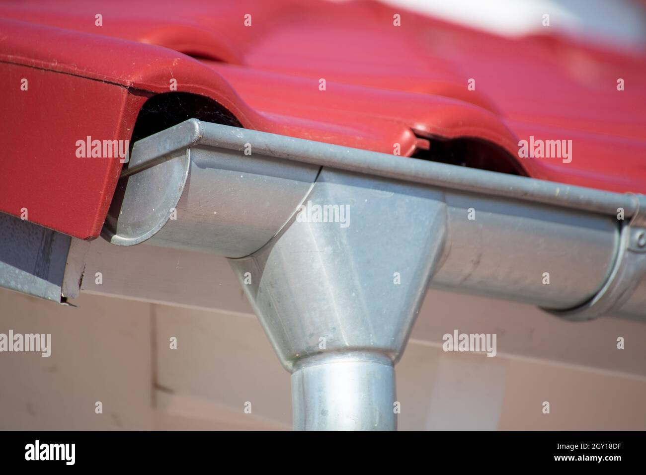 Roof gutter on a new tiled roof Stock Photo - Alamy