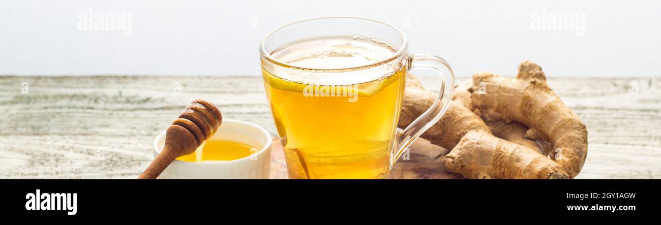 banner of Ginger tea with lemon and honey on a white wooden background ...