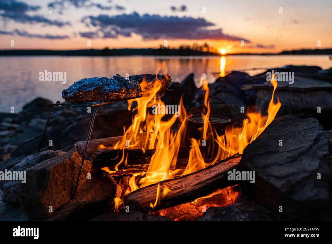 Preparing the dinner. Cooking on a bonfire onn a lonely island in ...
