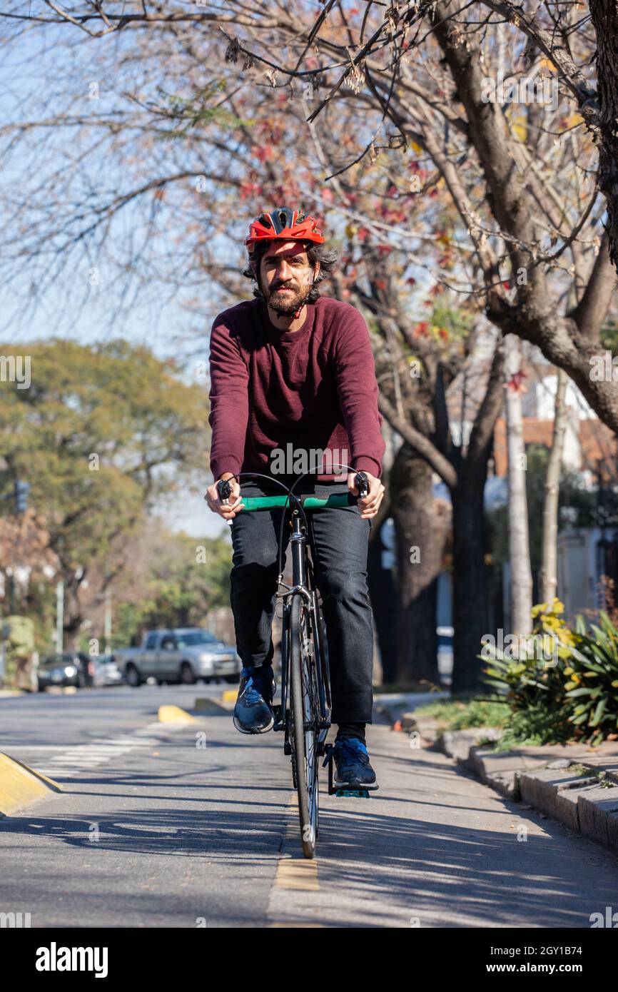 Vertical shot of a Caucasian male riding a bike in the morning Stock ...