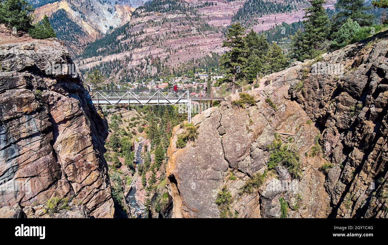 Aerial of deep canyon in the mountains with view of river and walking ...