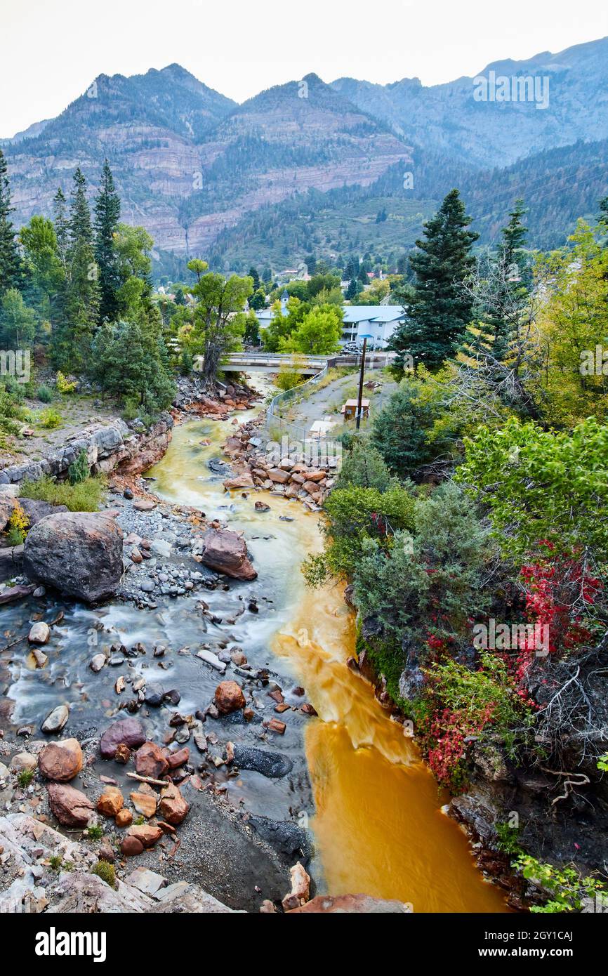 Clear and brown rivers mixing together in gorge with mountains in the ...