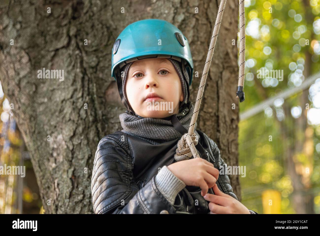 Portrait of preschooler boy in a protective helmet and ammunition ...