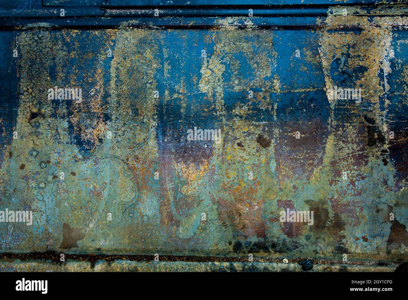 Blue and green and yellow patina painted on a wall textured background ...