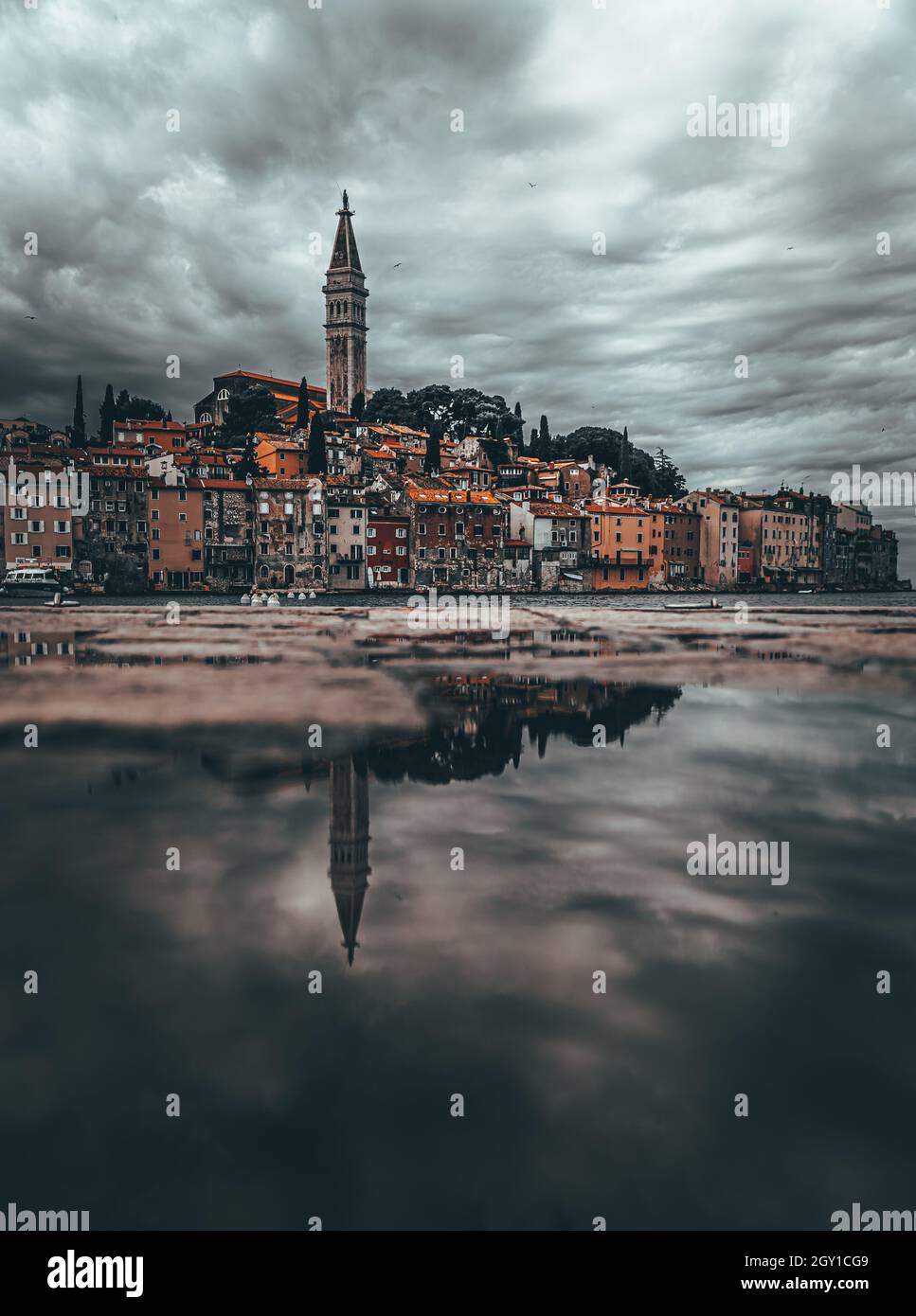 Vertical shot of the buildings of Rovinj in Croatia reflected in the ...