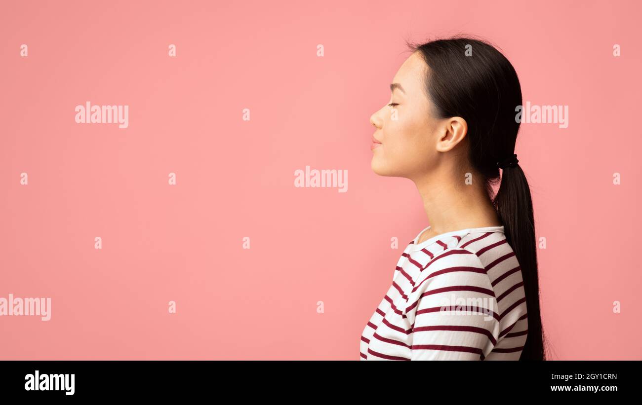 Profile Portrait Of Young Calm Asian Female Standing With Closed Eyes ...