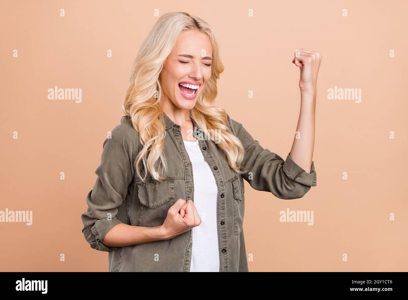 Photo portrait woman overjoyed gesturing like winner happy cheerful ...