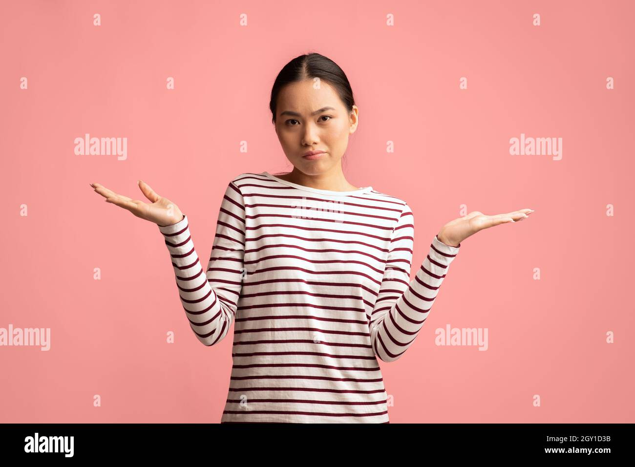 Difficult Choice. Doubtful Young Asian Woman Shrugging Shoulders And ...