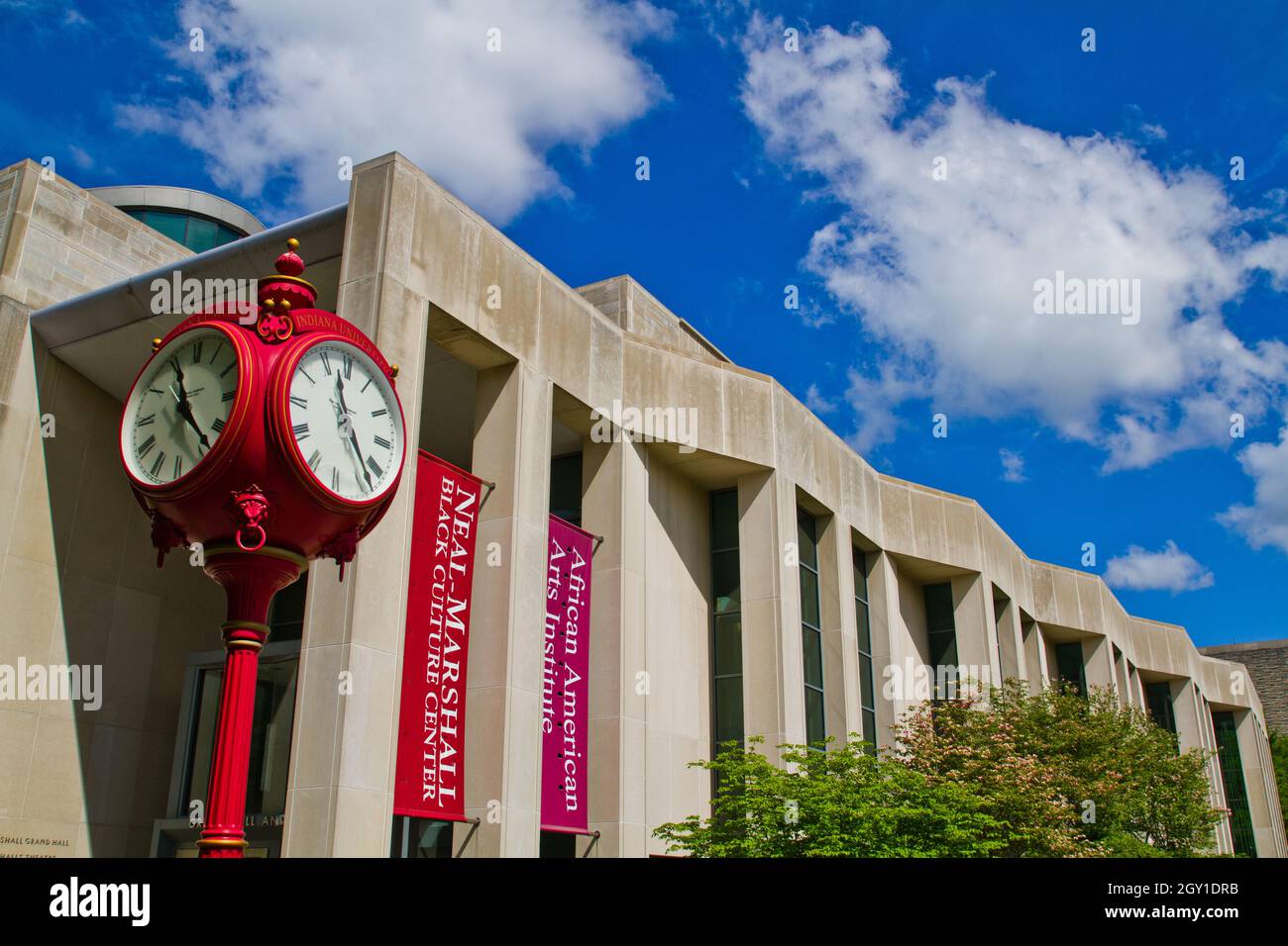 Red antique clock in front of a white stone building with unique ...
