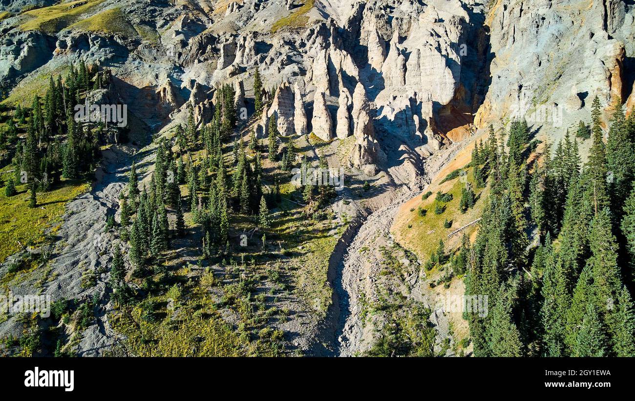 Close up of mountain slope with pillars of rock and pine trees Stock ...