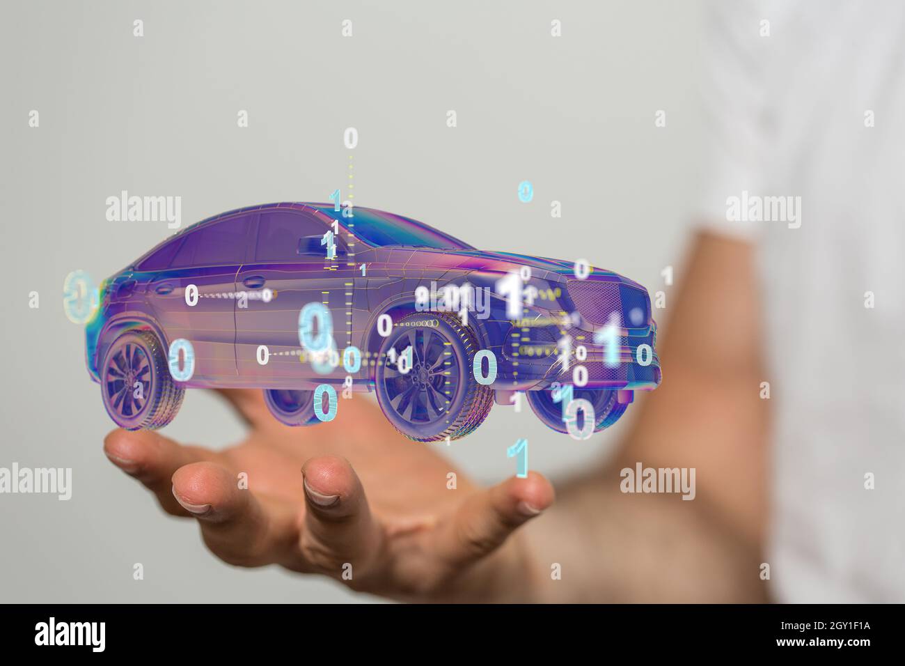 Abstract shot of a man's hand showing 3D rendered electric car in ...
