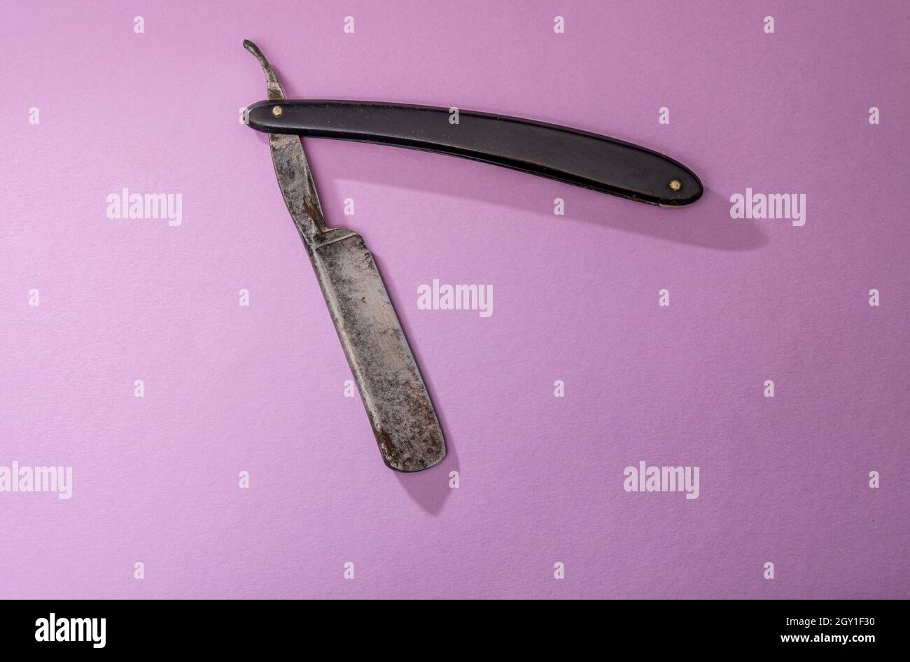 antique old cut throat or straight razor on a pink background Stock ...