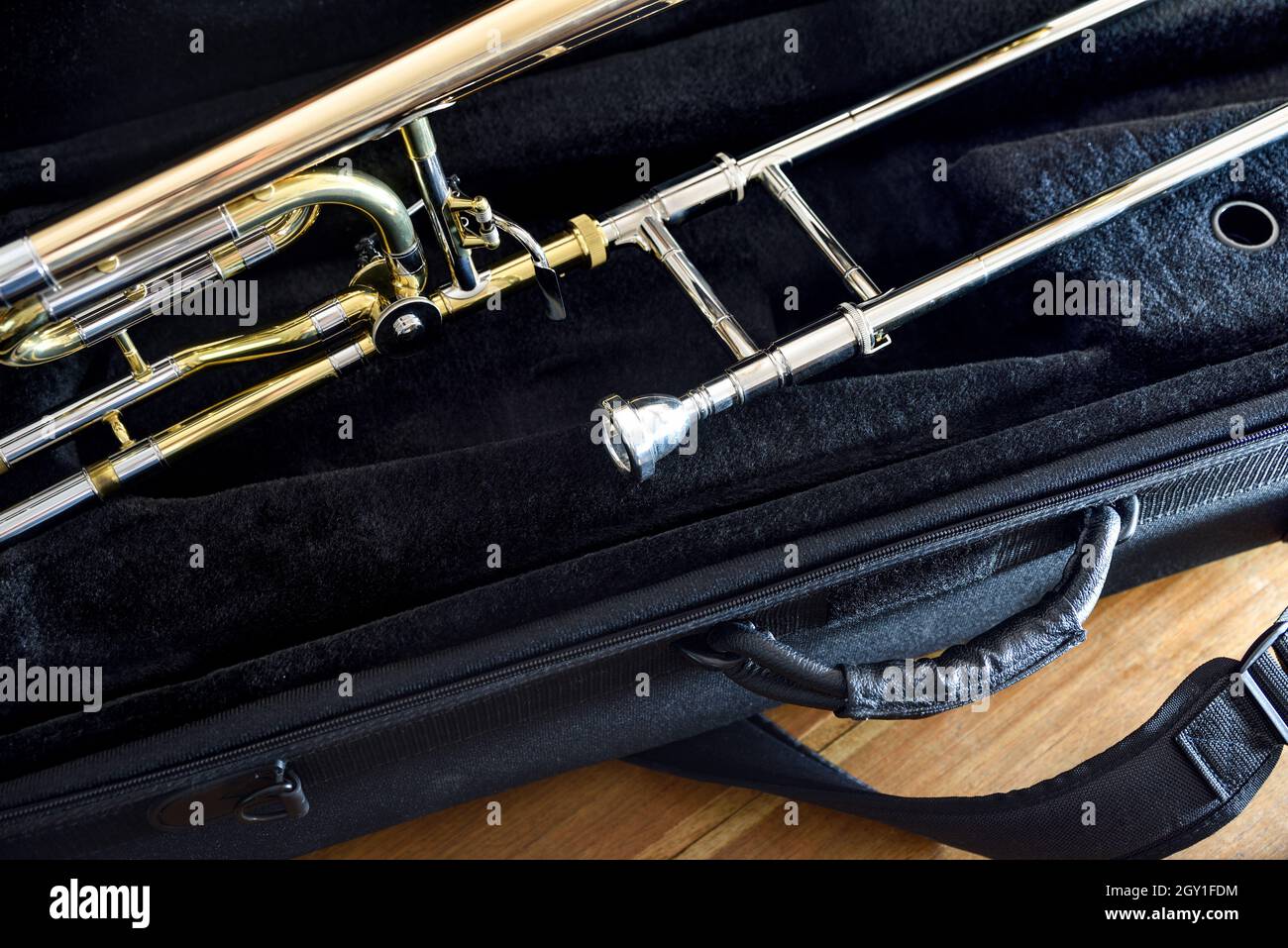 Trombone detail with transposer mounted and supported on suitcase. Top ...