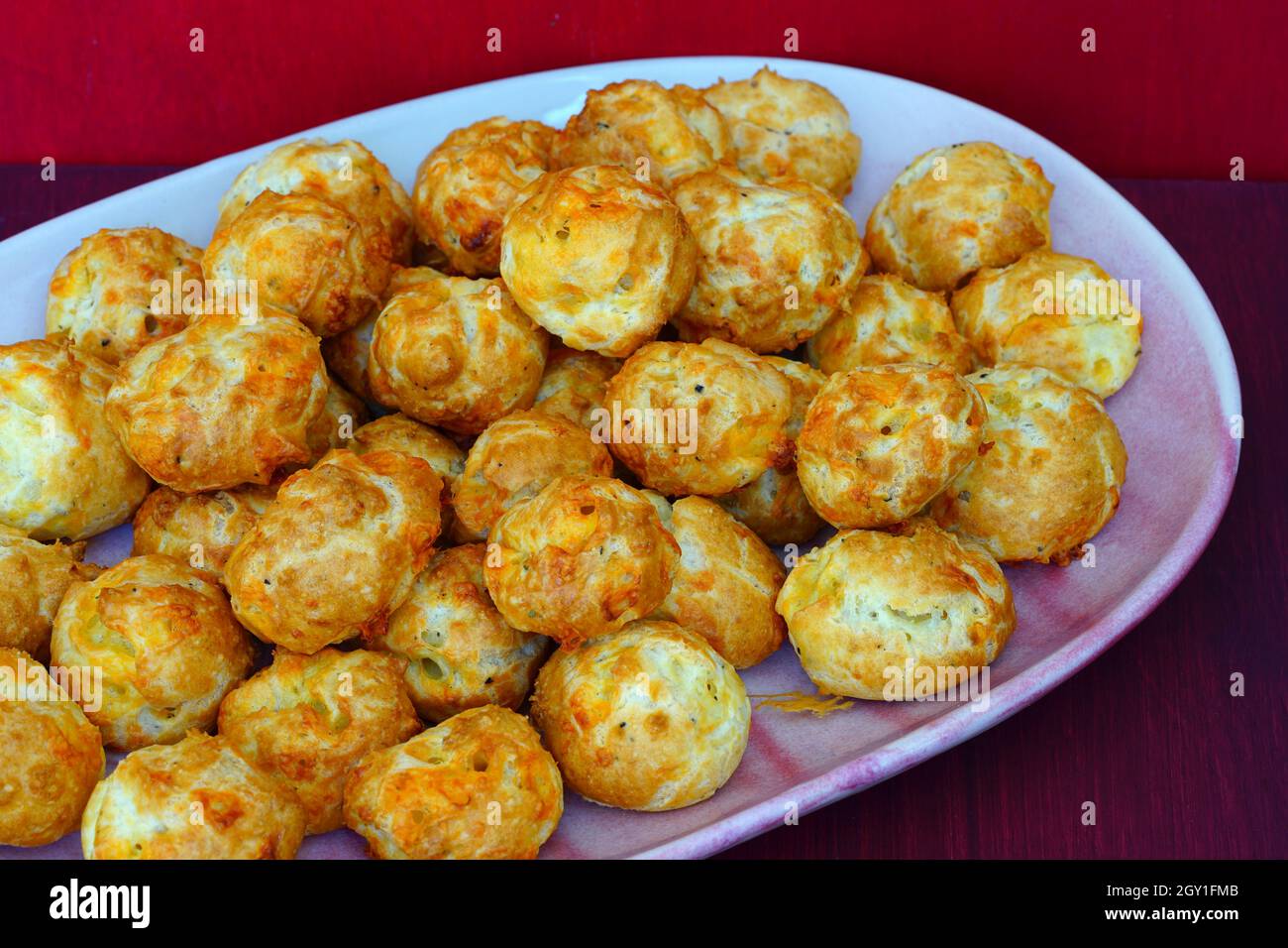 Platter of mini gougeres, pepper and cheese puffs Stock Photo - Alamy