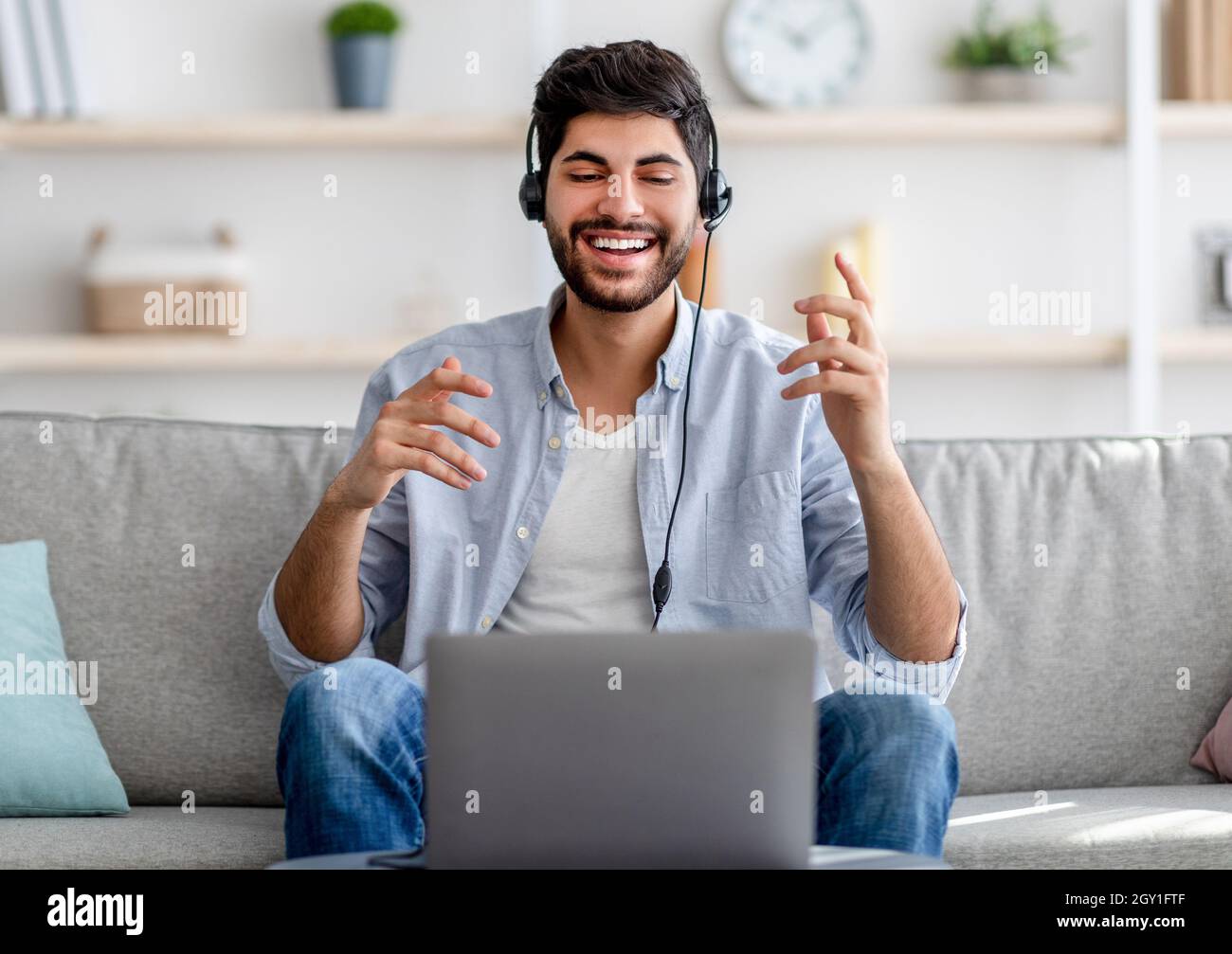 Distant communication concept. Happy millennial arab guy in headset ...