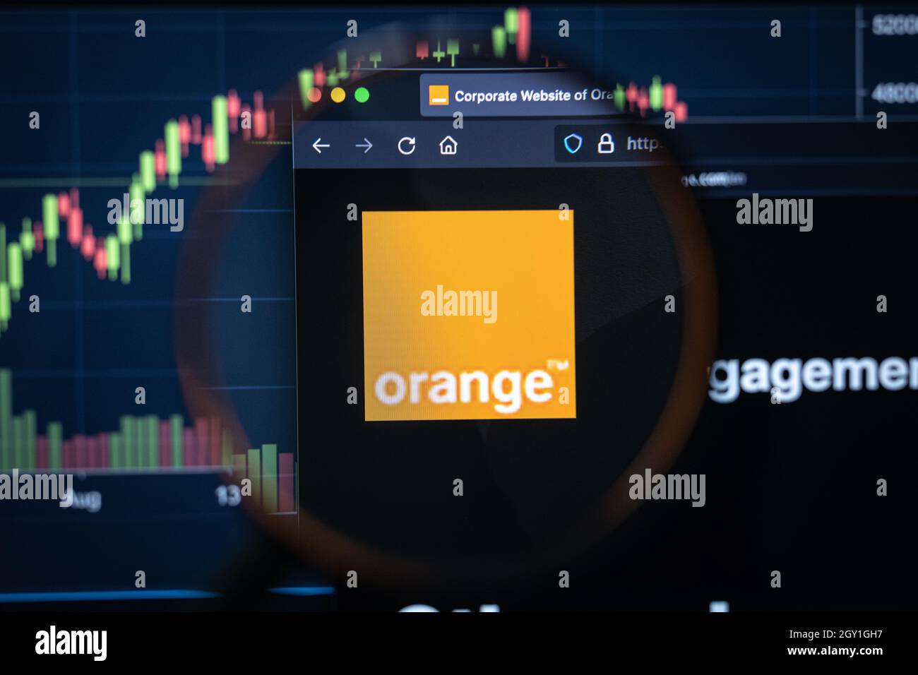 Orange company logo on a website with blurry stock market developments ...