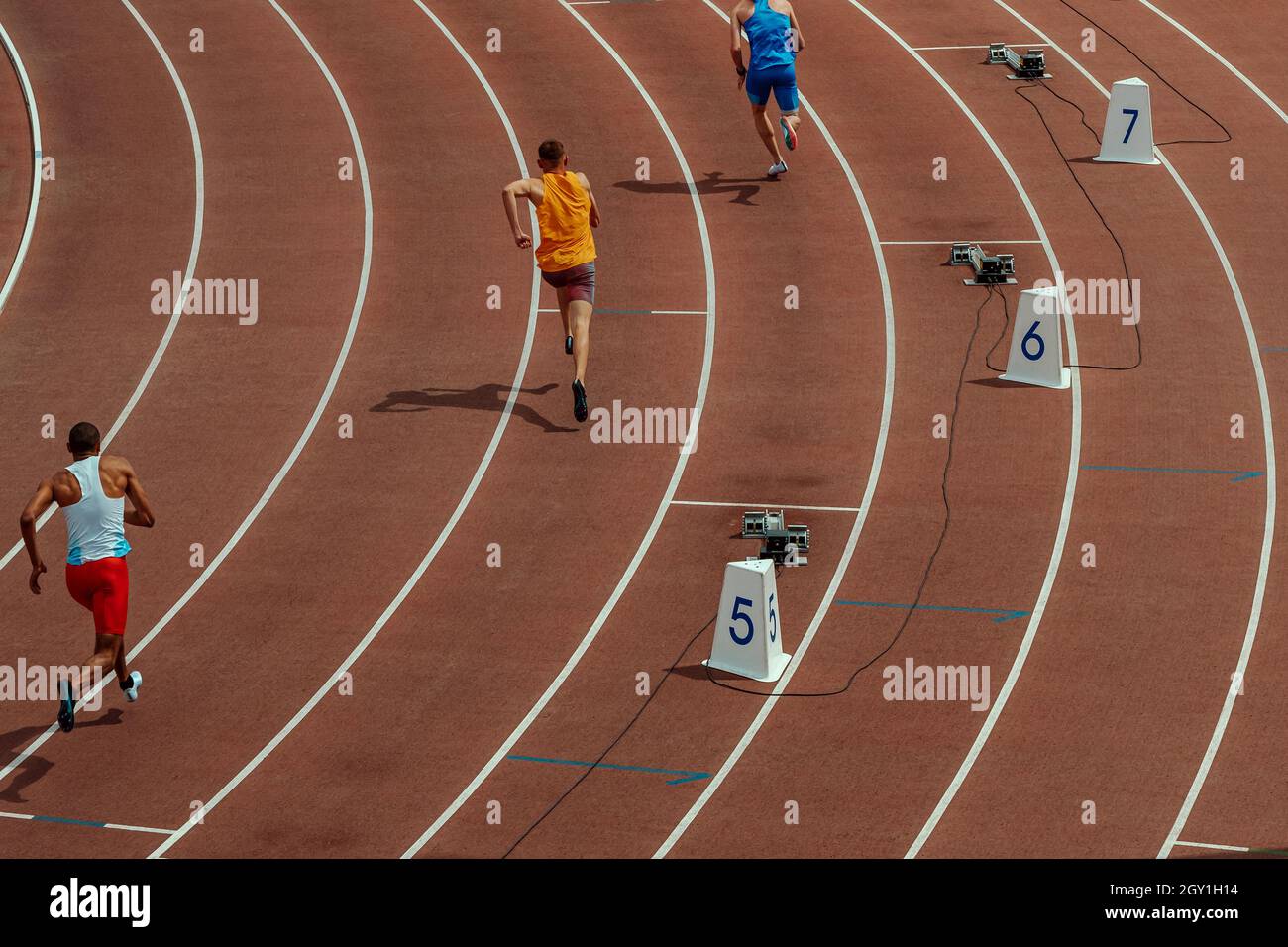 group of runners athletes start running 400 meters Stock Photo - Alamy