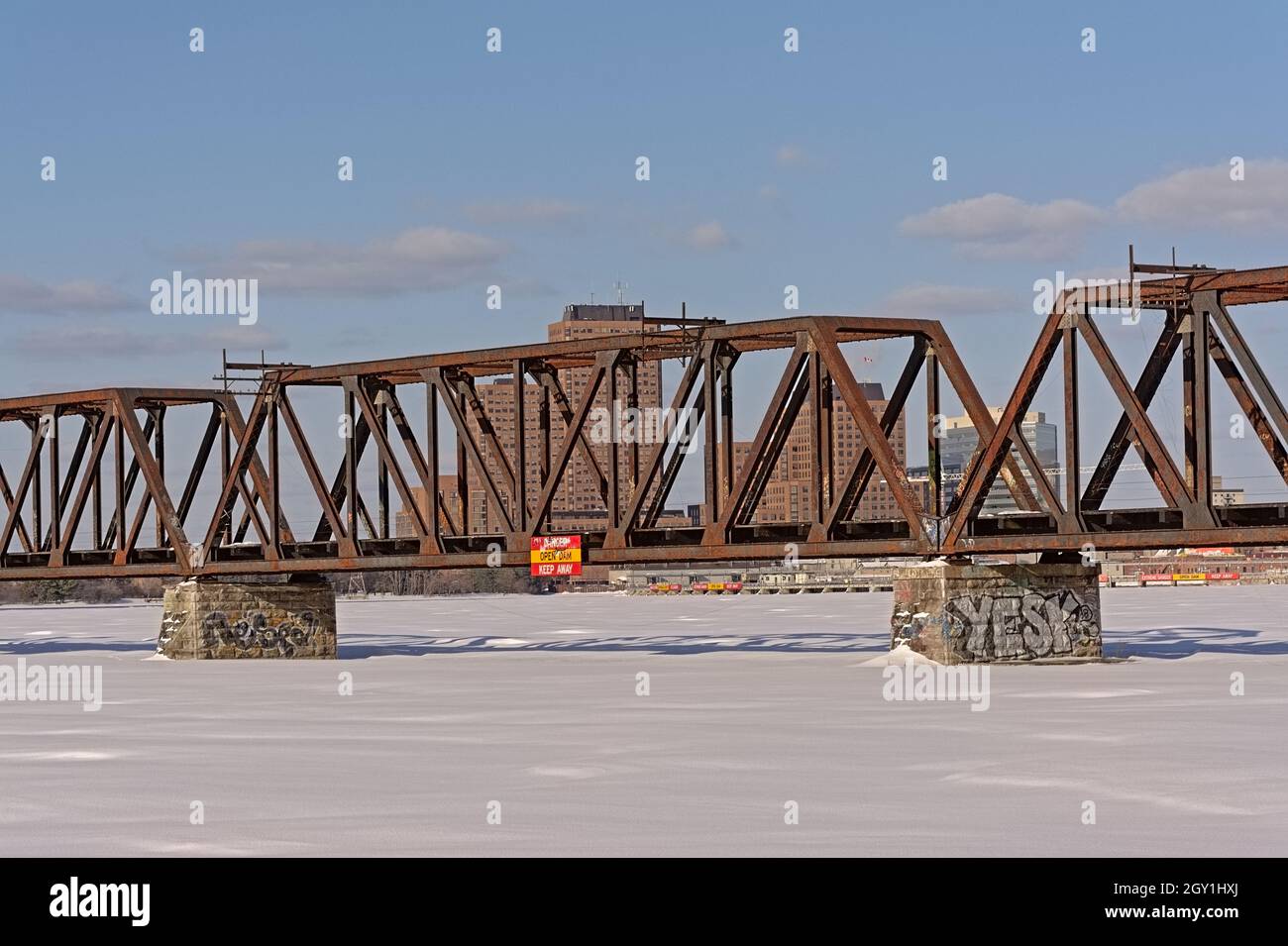 Prince of Wales rail bridge over frozen Ottawa river on a cold winter ...