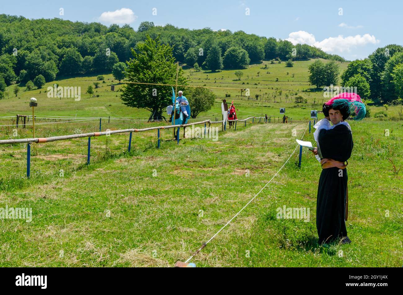 A man dressed as a handler of medieval knights at a renaissance ...