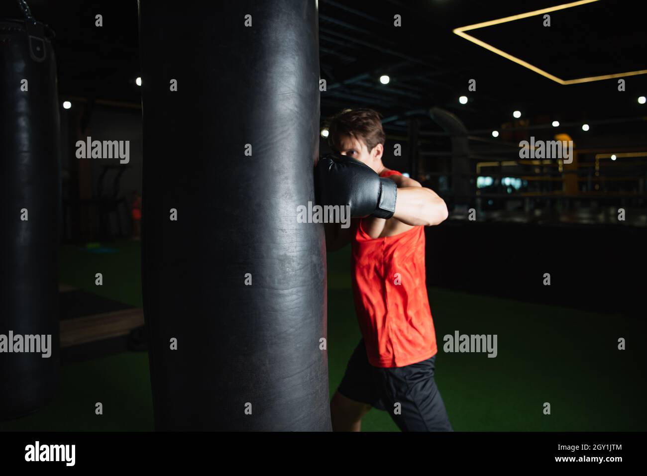 boxer working out with punching bag in sports center Stock Photo - Alamy