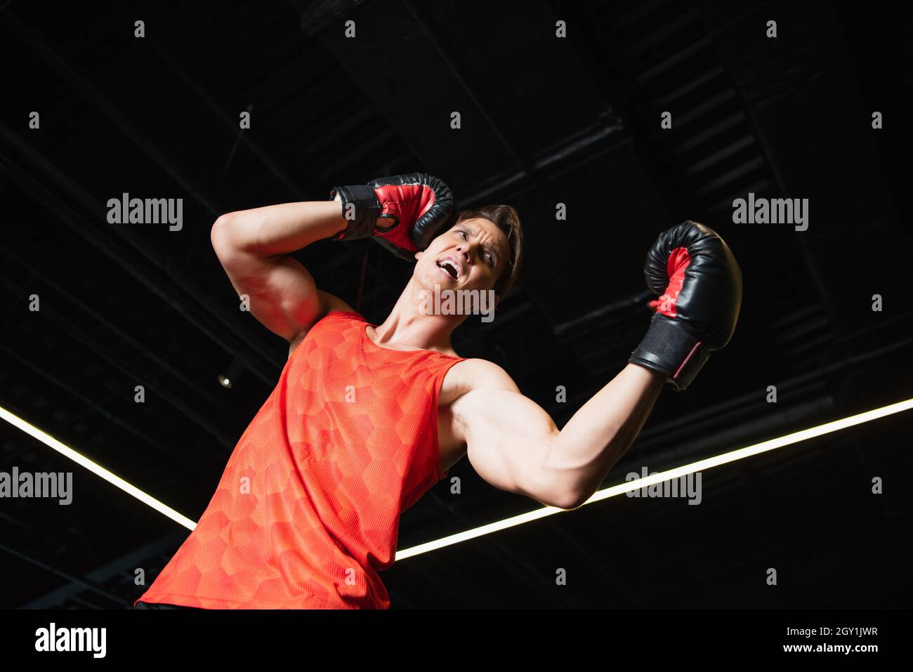 low angle view of boxer screaming while training in sports center Stock ...