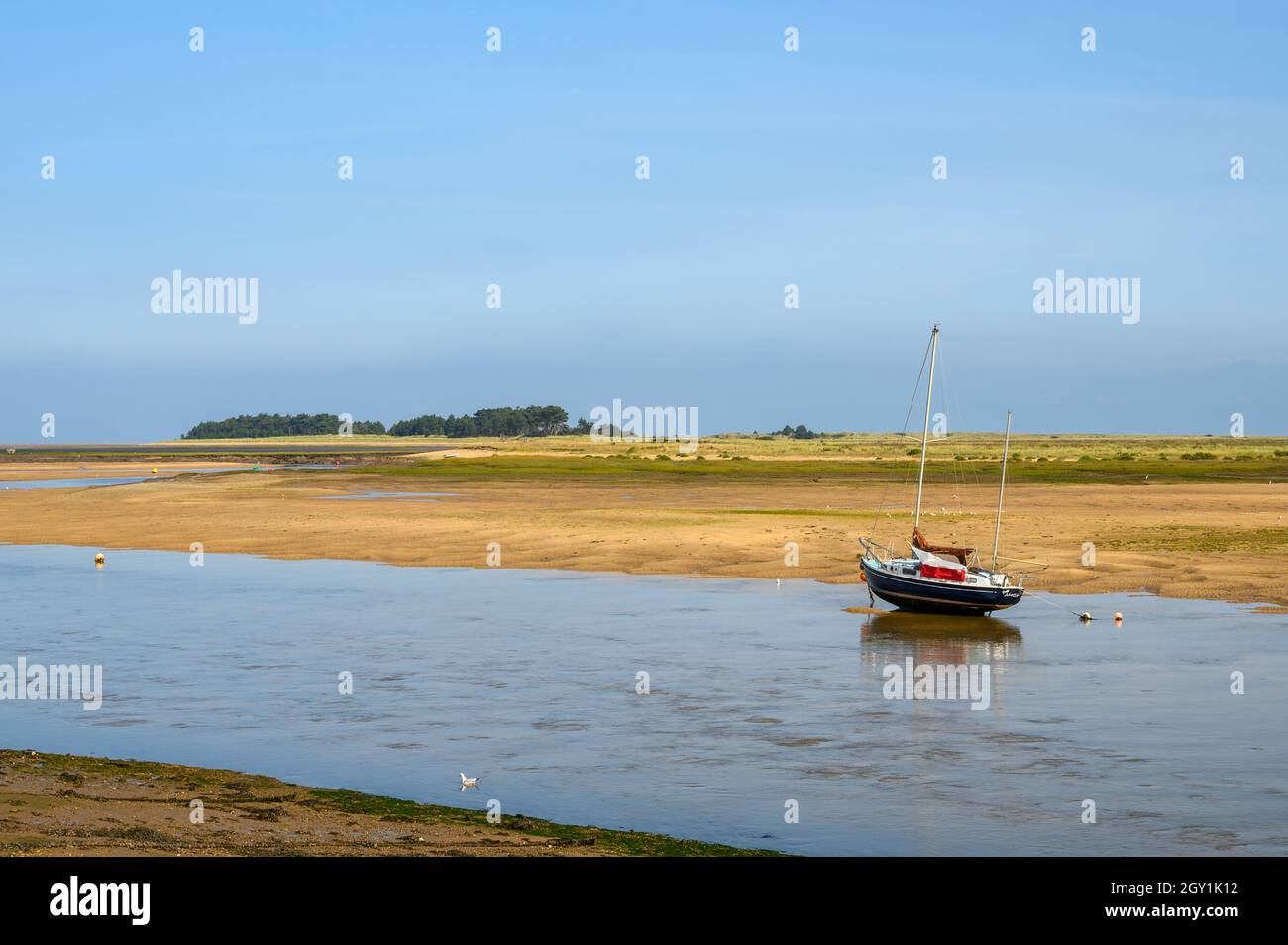 Sailboat sitting on the riverbed during low tide on East Fleet river ...