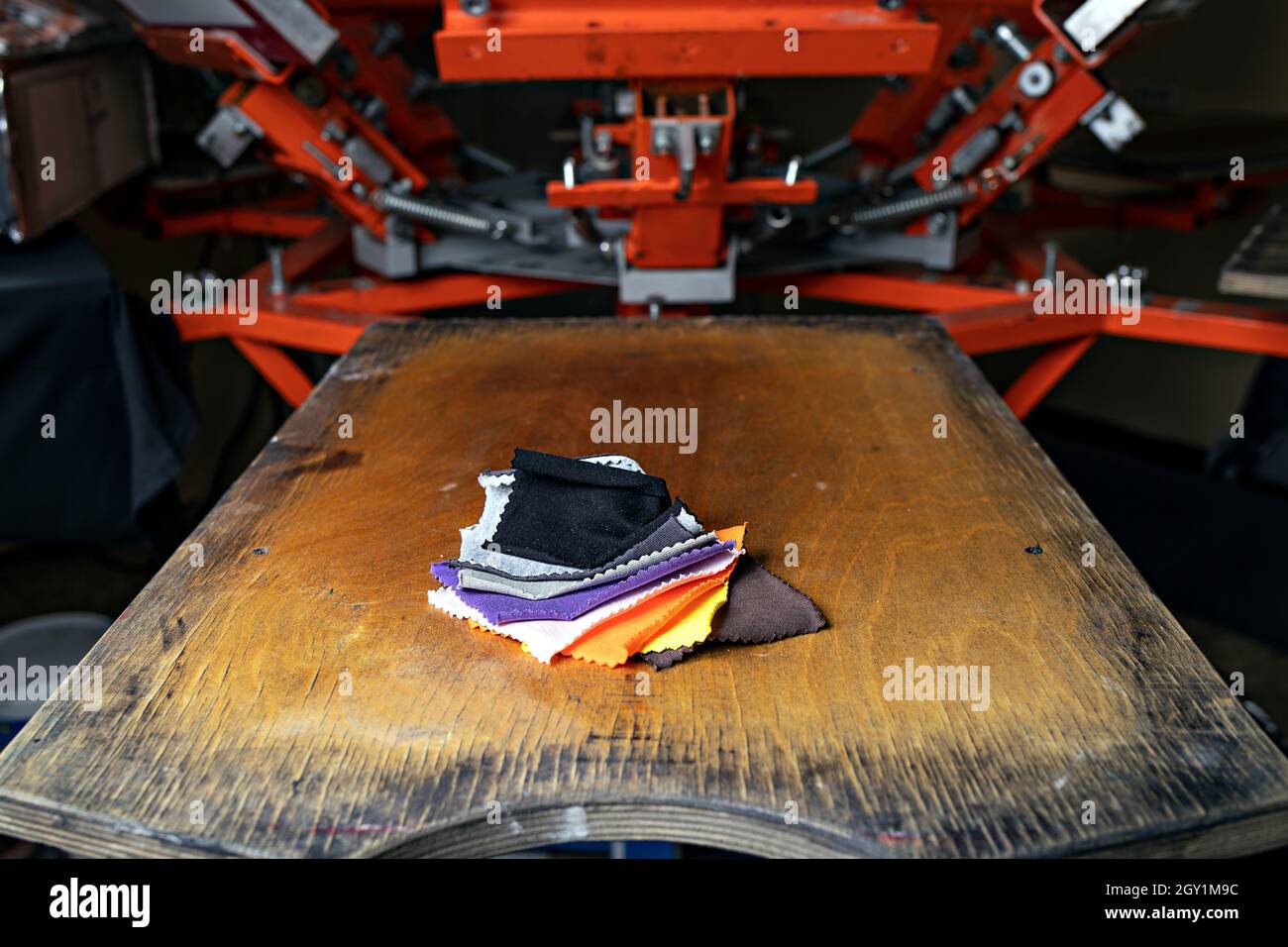 fabric samples on wooden shelve on the print screening apparatus. silk ...