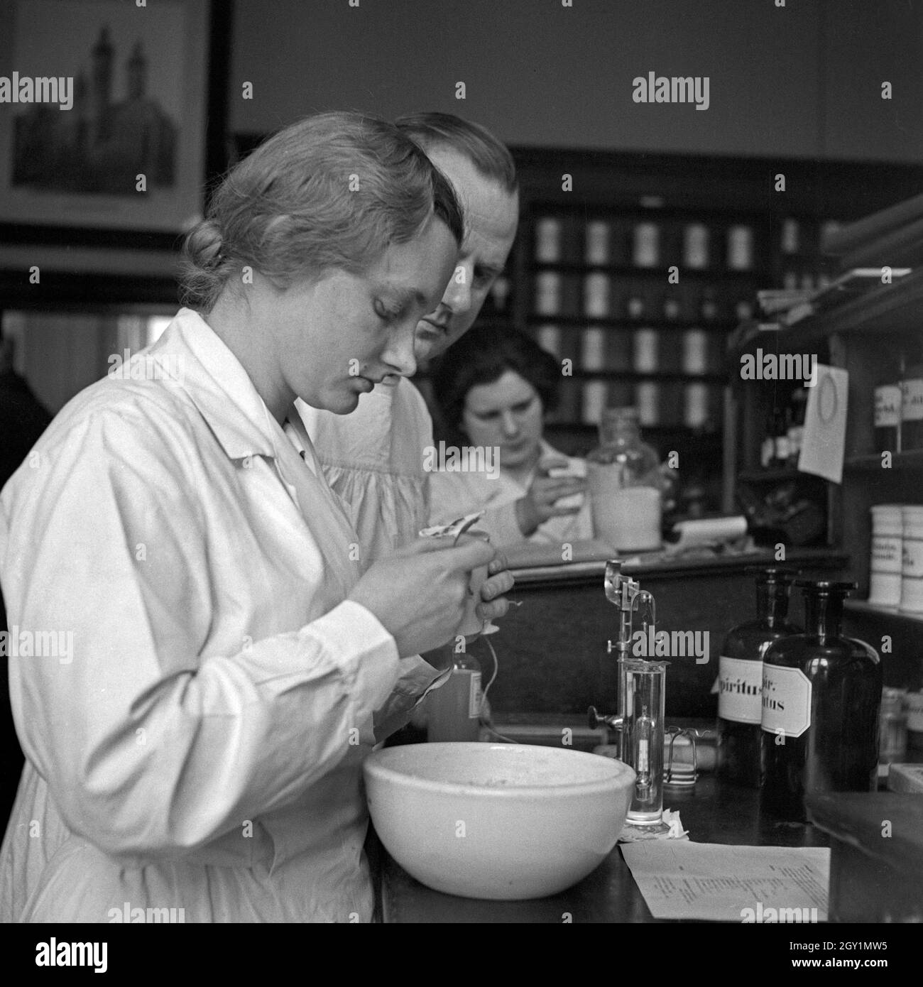 Eine Apothekerin mischt ein Medikament zusammen, Deutschland 1930er ...